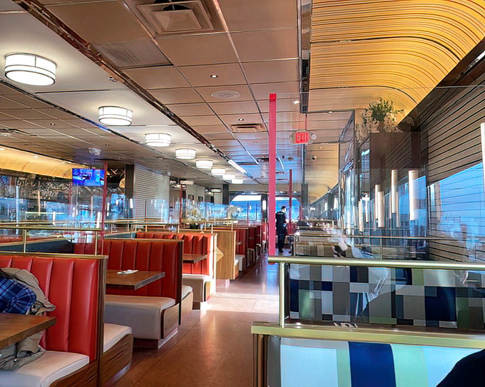Red vinyl booths invite you to slide in and stay awhile, under lighting that makes everyone look like they're starring in their own diner movie.