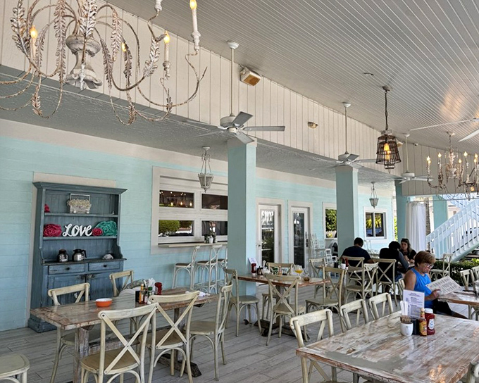 Chandeliers and ceiling fans create the perfect marriage of elegance and island practicality in this breezy dining space.