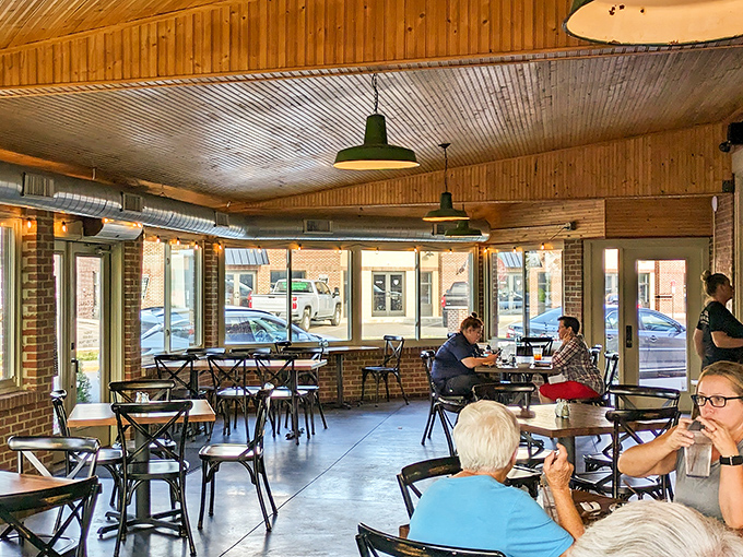 Sunlight streams through windows illuminating a dining room where strangers become friends, united by the universal language of "mmm" and "pass the napkins." 