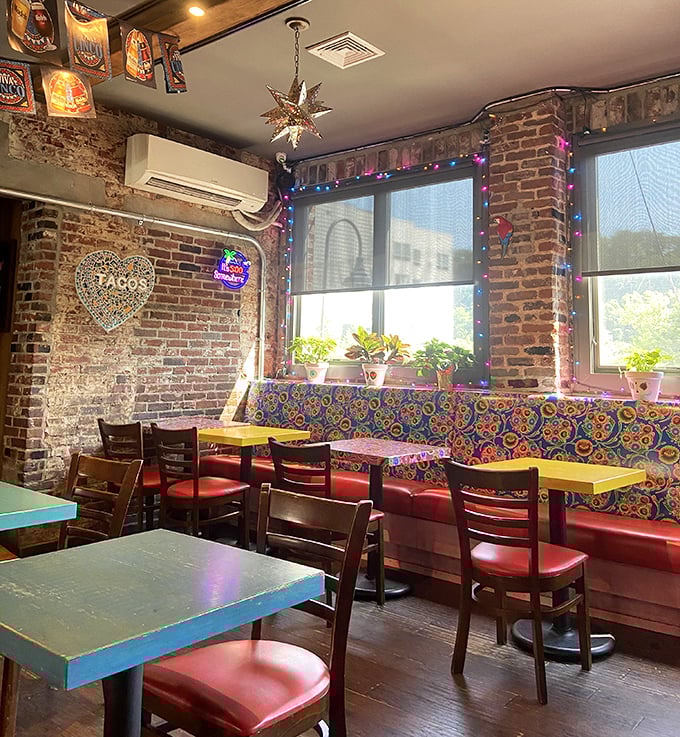 Colorful banquettes against rustic brick walls create the perfect backdrop for your "I'm about to eat something amazing" selfie.