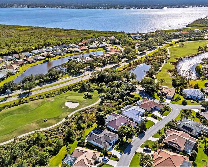 From above, Port Charlotte reveals its secret: a masterful blend of blue waterways, green golf courses, and neighborhoods nestled like they belong there.