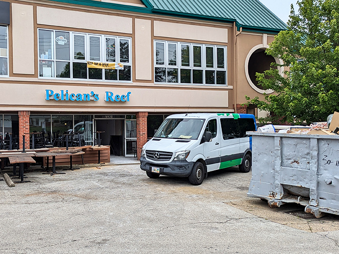 Even during renovations, the Pelican's Reef sign stands proud. Good seafood requires commitment, even when the dumpster's in the parking lot.