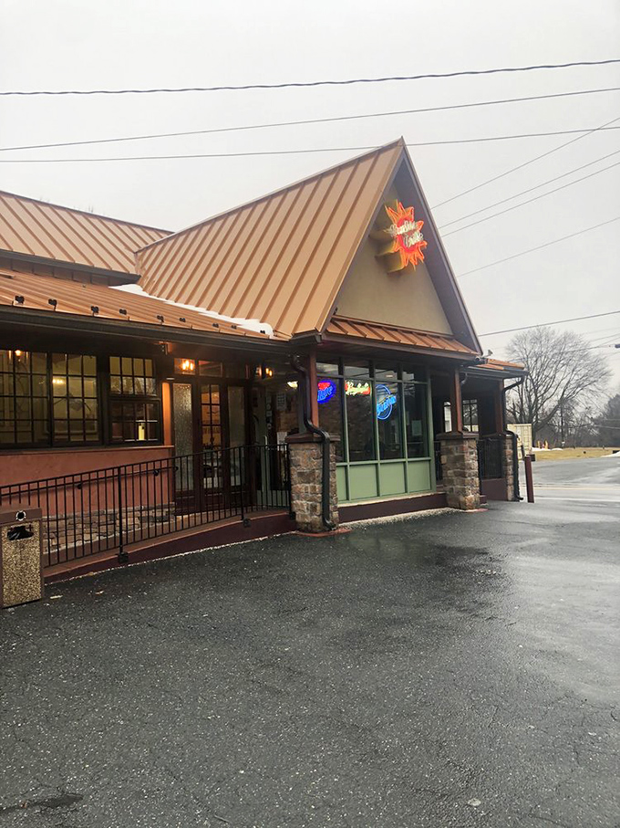 Even on a gray day, that iconic sun logo shines bright, promising warmth and satisfaction just beyond those stone pillars.