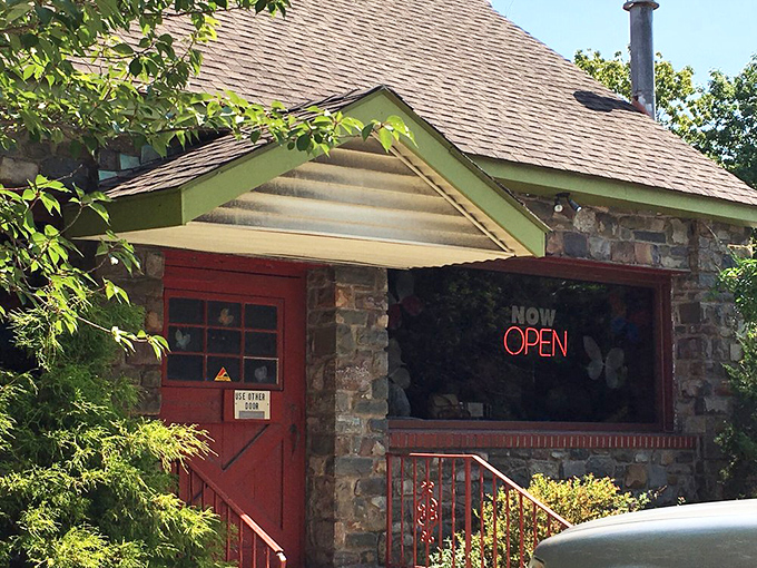 Red doors and stone walls welcome you like a fairy tale cottage where the happy ending involves maple syrup and coffee refills.