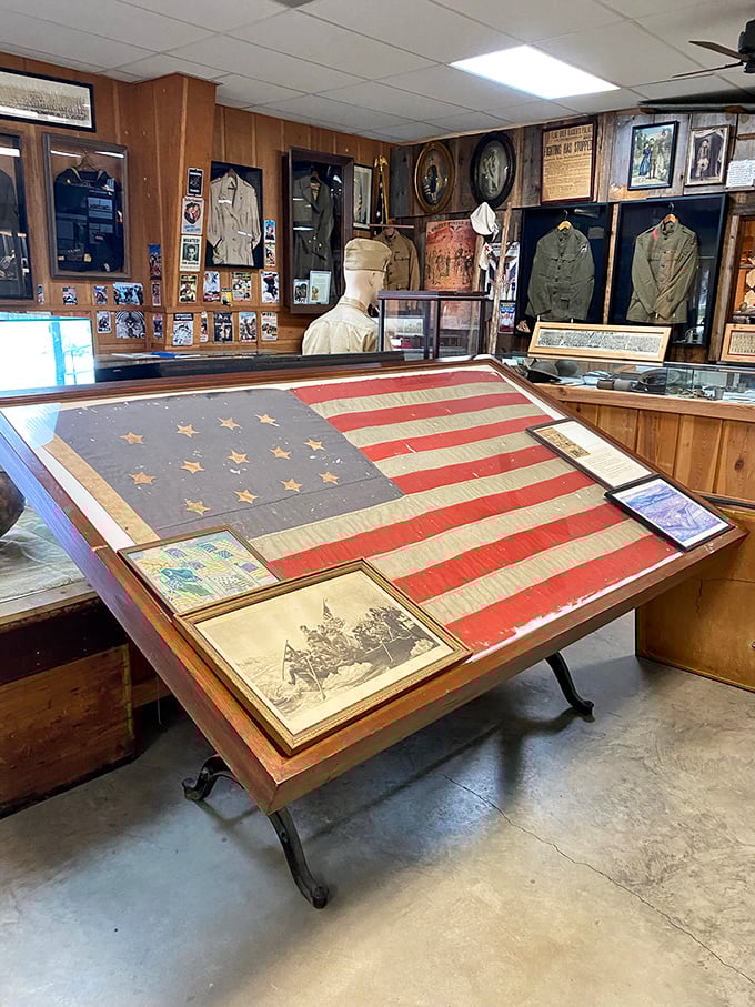 This military exhibit showcases the historic American flag alongside uniforms that tell stories of sacrifice and service through generations.