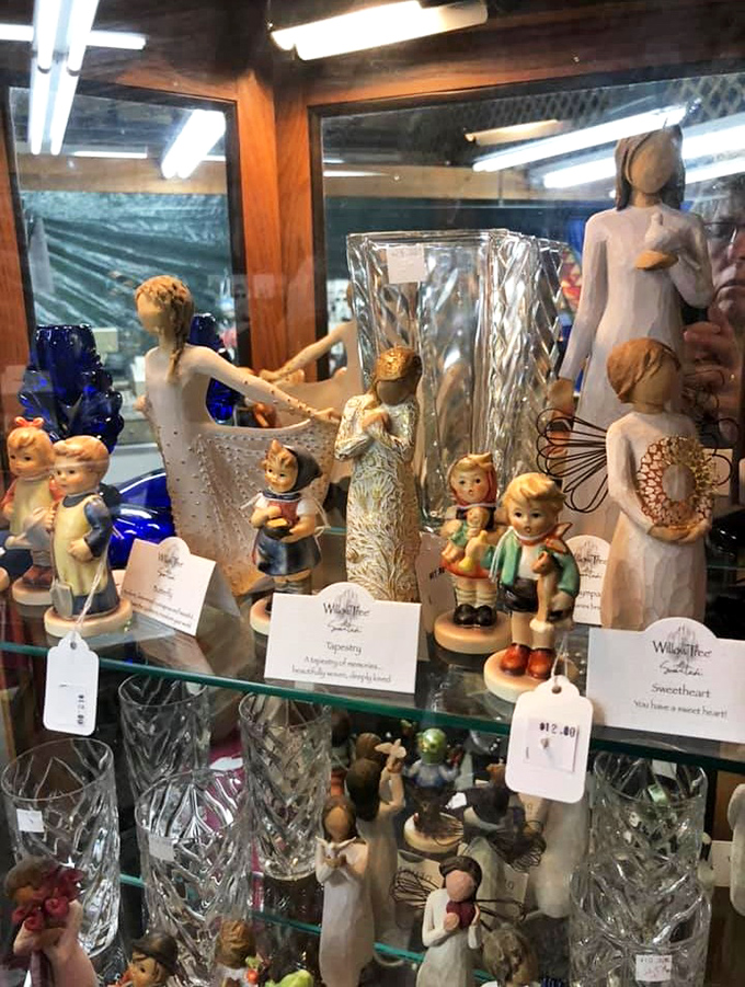 Willow Tree figurines and crystal treasures stand at attention, waiting for someone to rescue them from their glass prison and give them purpose again.