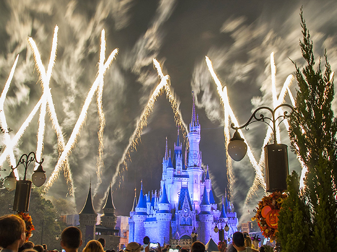 The castle stands sentinel as fireworks paint the night sky, creating that quintessential Disney moment worth braving the crowds for.