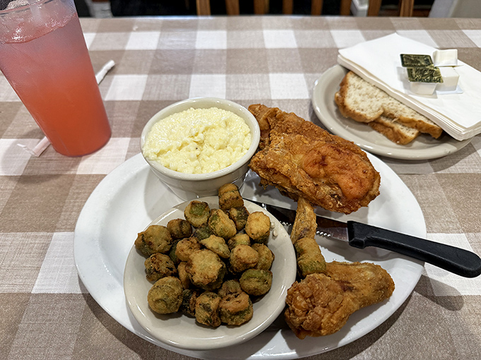 Fried chicken that audibly crackles with each bite, nestled alongside potato salad and okra that would make any Southern grandmother nod in approval.