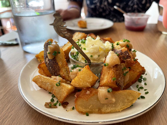 Golden potatoes wearing a crown of crème fraîche and chives—humble spuds transformed into royal treatment.