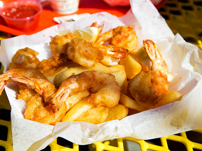 These golden fried prawns nestled among crispy fries are what seafood dreams are made of.