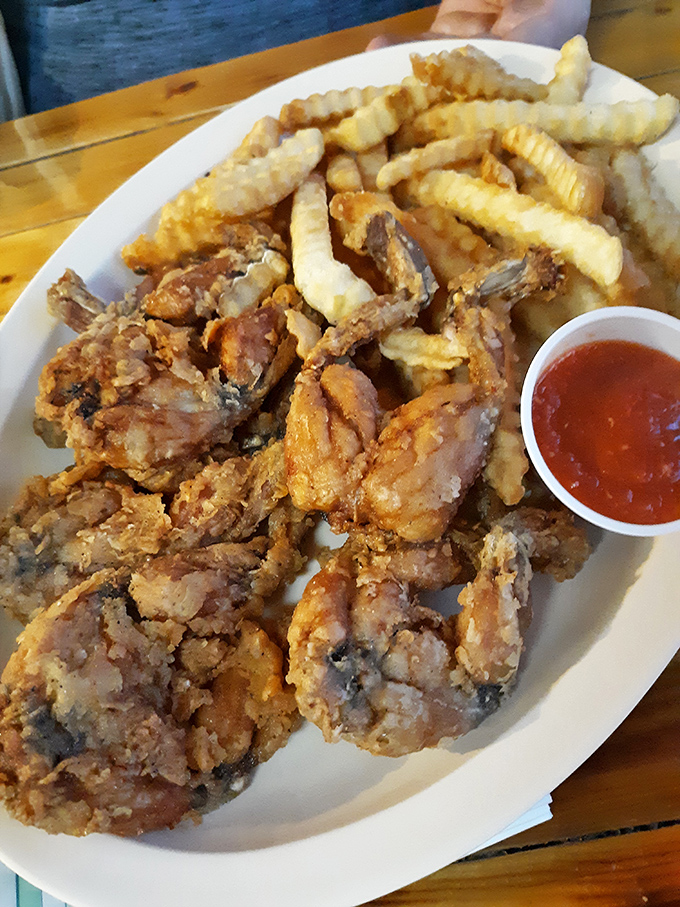 Crispy fried frog legs with perfectly golden fries&mdash;proof that sometimes the most unexpected menu items deliver the most memorable meals. Tastes like chicken? Only better.