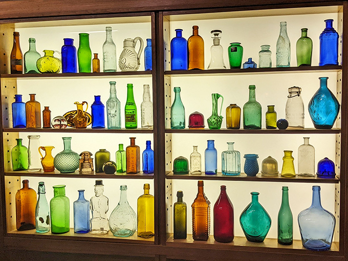 A rainbow of vintage bottles catches the light like an analog Instagram filter. Glass treasures from an era when even medicine looked beautiful.
