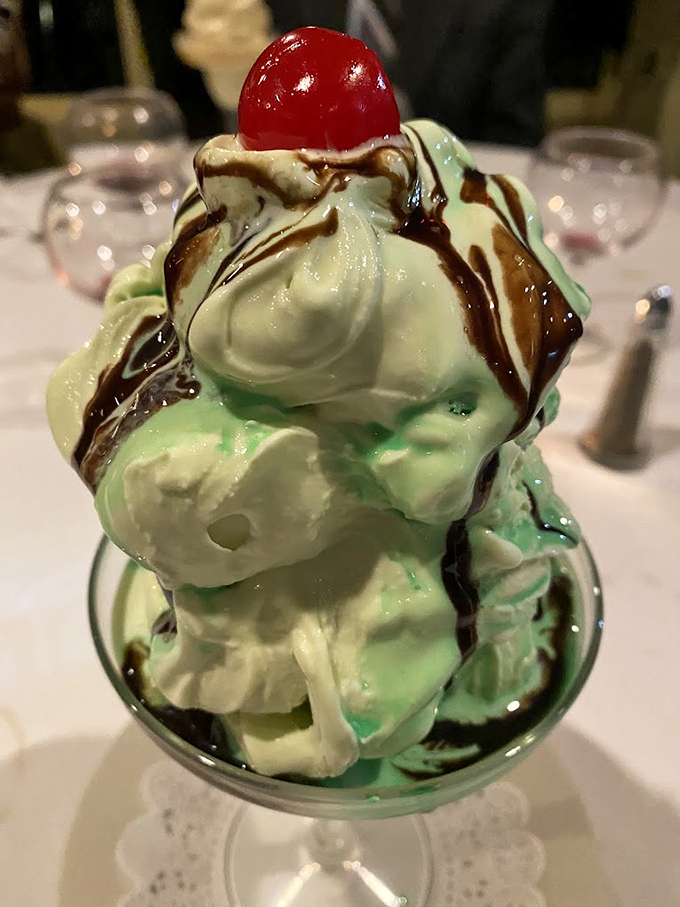 This isn't just mint chocolate chip ice cream; it's a towering monument to dessert excess, complete with chocolate drizzle and cherry crown.