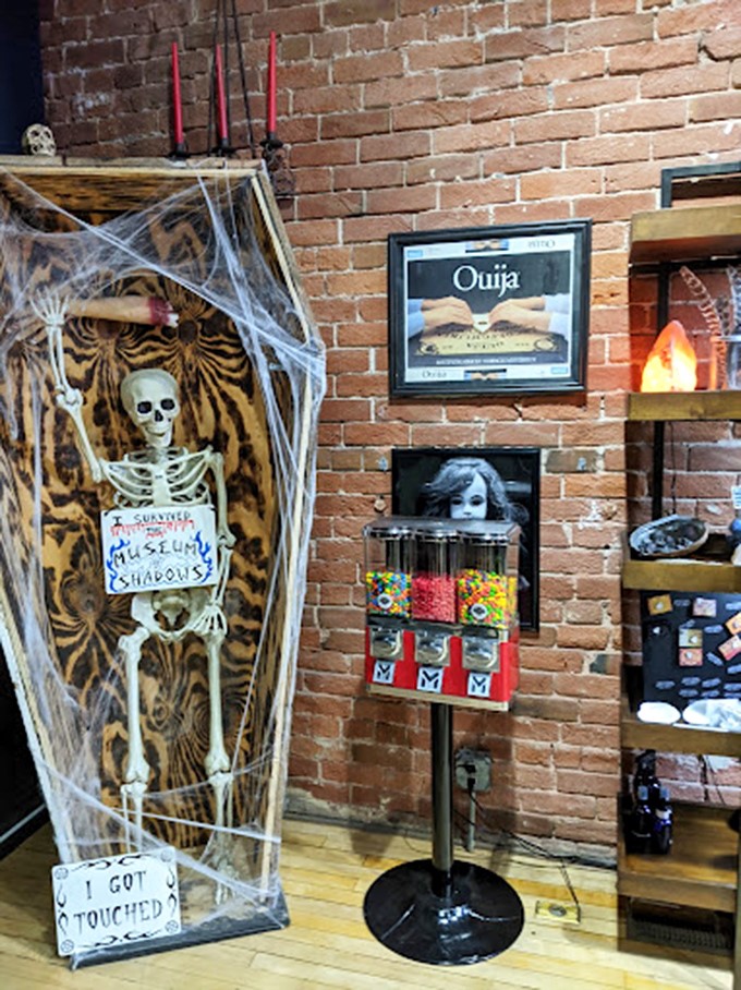 A skeleton wrapped in cobwebs greets visitors with macabre humor. "I got touched" reads his sign&mdash;the museum's version of gallows humor.