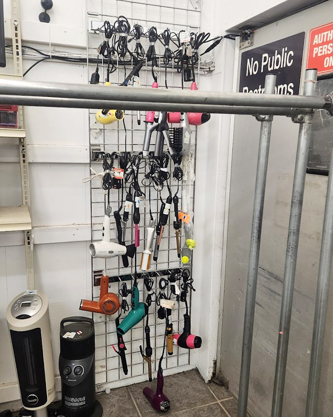 A wall of forgotten electronics and styling tools&mdash;technological time capsules hanging in suspended animation. Yesterday's innovations waiting for tomorrow's nostalgic collector.