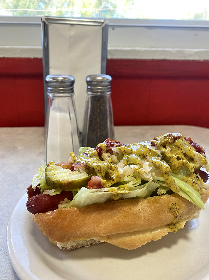 This isn't just a hot dog—it's a canvas of culinary creativity topped with enough goodies to make Oscar Mayer weep with pride.