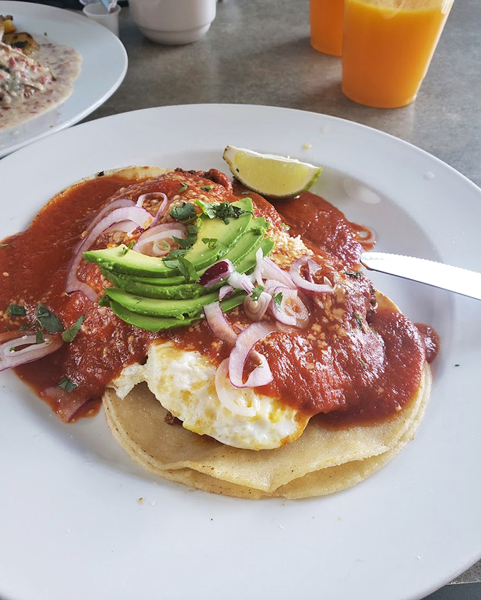 Huevos rancheros that bring a fiesta to your morning, with avocado slices standing by to cool things down when the salsa kicks in.