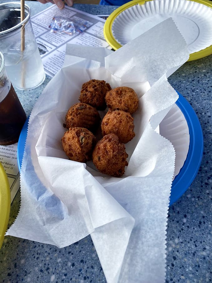 Hush puppies that aren't asking for silence but applause &ndash; golden-brown orbs of cornmeal perfection that disappear faster than Florida sunshine after a summer storm.