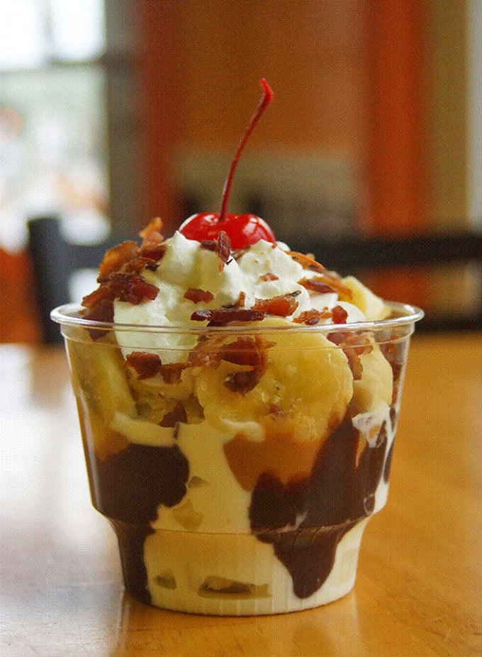 Layers of ice cream, hot fudge, and banana create a sundae that's basically therapy in a cup. The cherry on top isn't optional&mdash;it's essential.