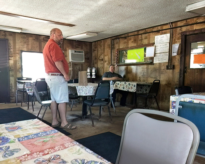 Two patrons sharing the sacred space of a true BBQ temple. No dress code required&mdash;just bring your appetite.