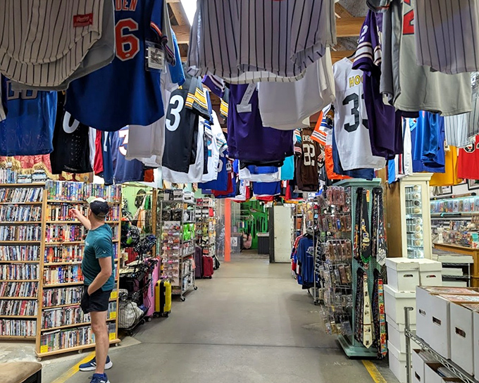 Sports memorabilia alley, where team loyalties hang overhead like championship banners. DVDs and collectibles await fans who remember when players stayed with one team.
