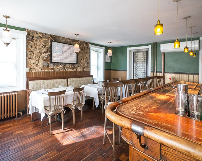 The bar area whispers of conversations past, where polished wood and exposed stone walls have witnessed countless first dates and anniversary toasts.