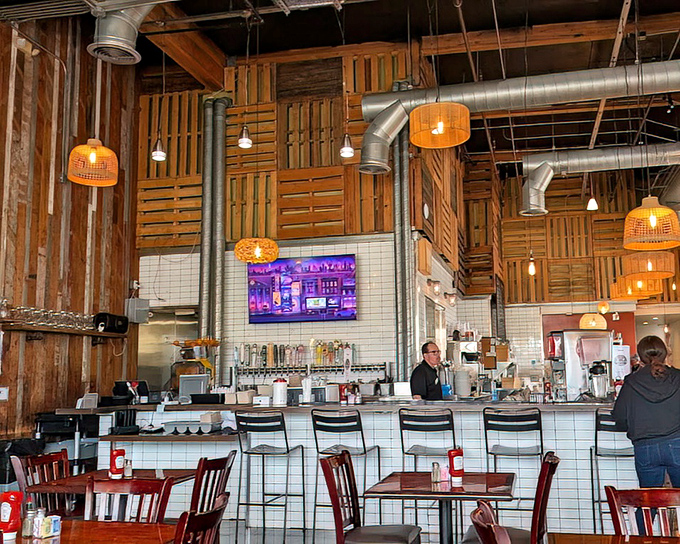 The bar area showcases that beautiful wood paneling and industrial touches. Where sports on TV and good conversation flow as freely as the drinks.