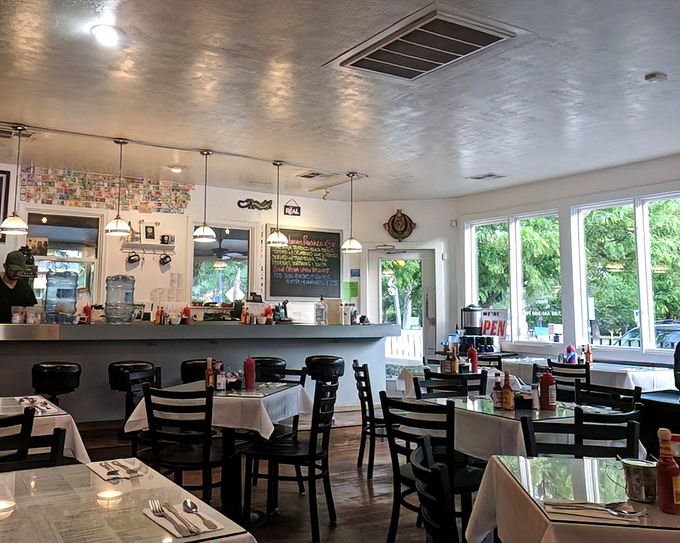Morning light streams through windows as diners enjoy their breakfast sanctuary, where coffee flows and conversation hums like a well-tuned engine.