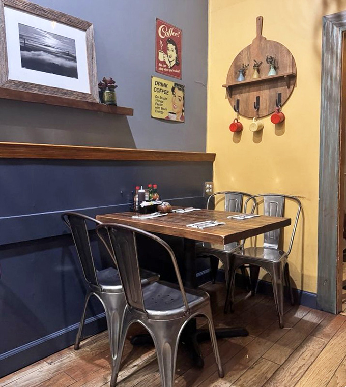 Vintage coffee signs and wooden accents create that rare atmosphere where hipsters and retirees find common ground over perfect pancakes.