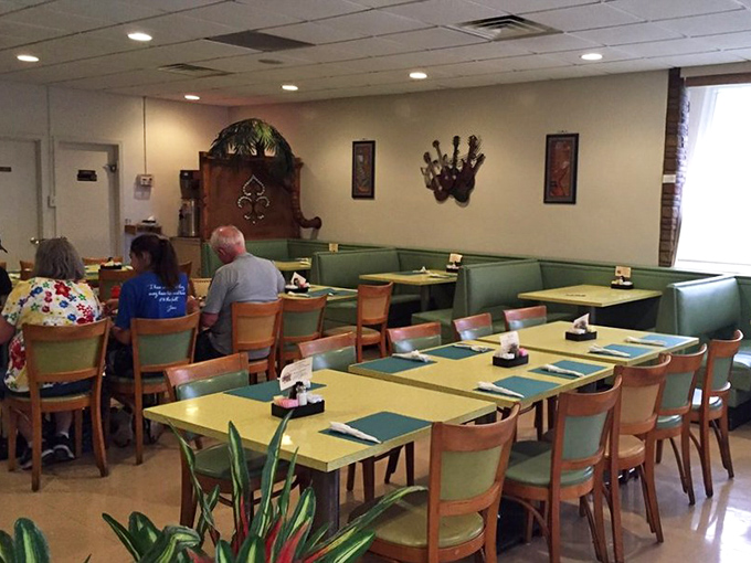 The dining room's mint-green booths and yellow tables create that perfect nostalgic atmosphere where conversations flow as easily as the coffee.