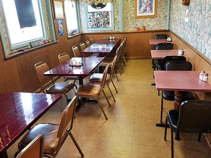 Simple tables, wood paneling, and floral wallpaper create the dining equivalent of a warm hug. This isn't interior design; it's comfort architecture at its finest.