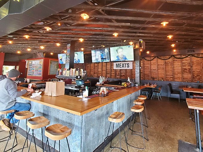 The bar area combines industrial chic with barbecue functionality&mdash;a place where "MEATS" isn't just a sign, it's a philosophy.