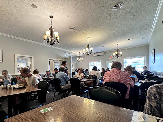 Multiple chandeliers casting their glow over happy diners &ndash; fancy enough to feel special, relaxed enough to breathe.