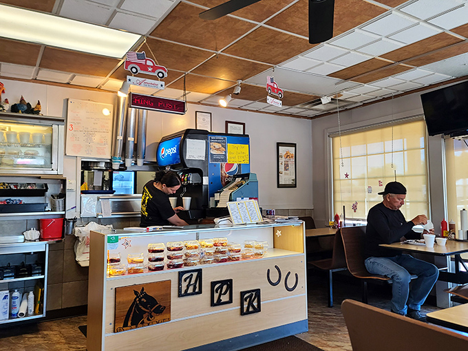 The counter where magic happens daily. Those toy cars hanging from the ceiling aren't just decoration&mdash;they're keeping watch over culinary treasures below.