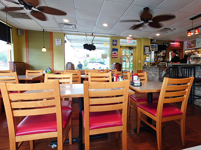 Sunlight streams through windows, illuminating wooden tables where countless Orlando mornings have begun. The ceiling fans keep things cool in Sunshine State style.