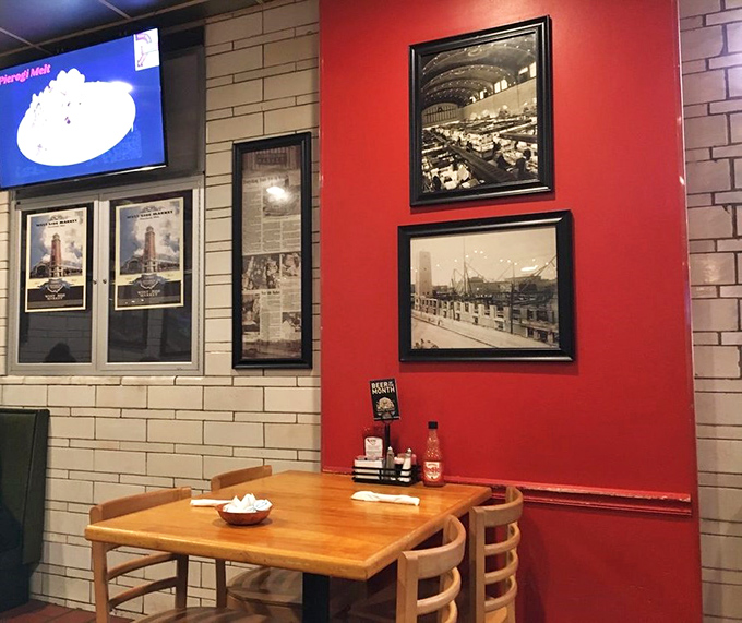 Red accent walls and historical market photos remind you that you're dining in a place where food stories have been unfolding for generations.