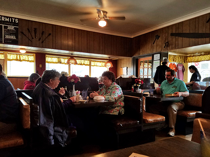 Every small town needs a gathering place like this, where ceiling fans spin stories and windows frame the neighborhood beyond.