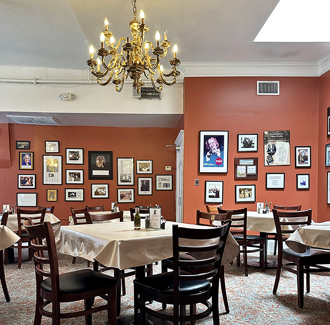 Warm terracotta walls adorned with framed memories tell stories of Atlanta's past while chandeliers cast a golden glow over present-day feasts.
