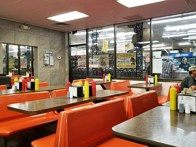 Orange booths and condiment bottles standing at attention—this isn't just a dining room, it's a stage where comfort food performs its greatest hits.