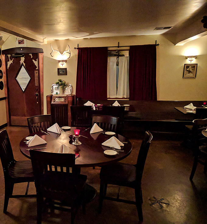 Dining room ambiance that strikes the perfect balance between "special occasion" and "come as you are" &ndash; white napkins meet rustic antlers.