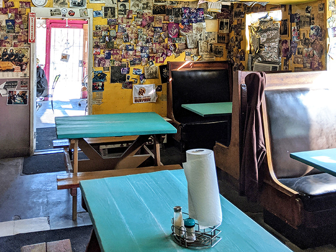 No designer touched this space. The turquoise tables, paper towel rolls, and walls plastered with memories create the perfect stage for meat-centered magic.