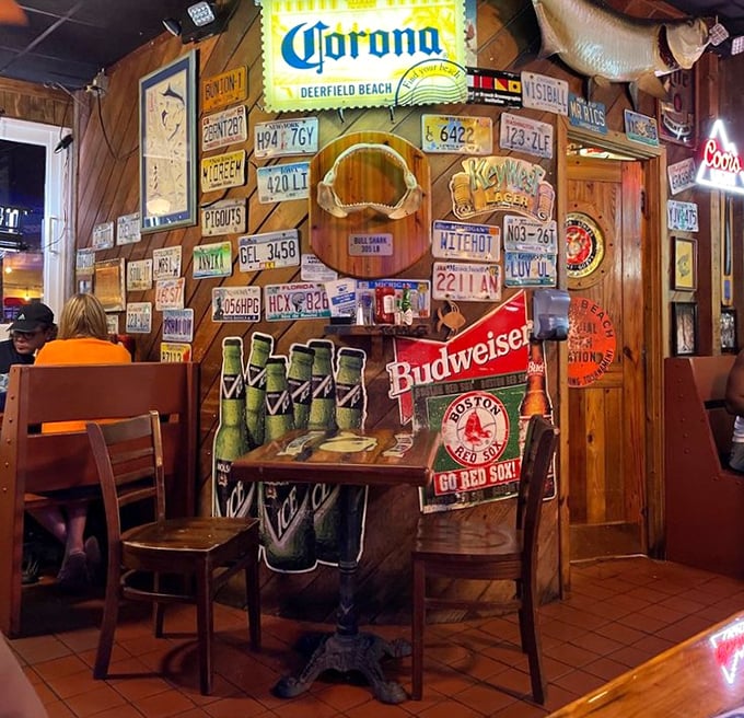 Where beer signs glow and license plates tell stories of travelers who found their way to this seafood sanctuary. Every inch has earned its patina.