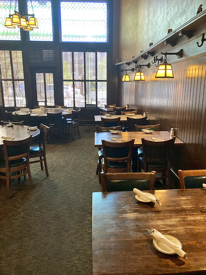 Tables set with simple elegance, waiting for the next round of diners to create memories under the glow of those craftsman-style lamps.