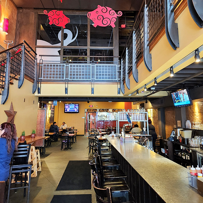 Two-story dining with industrial chic vibes&mdash;because sometimes you need architectural drama to match the intensity of your barbecue experience.