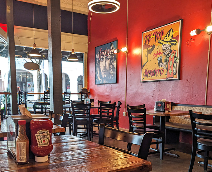 Bold red walls and eclectic art create the perfect backdrop for burger consumption. This isn't corporate dining; this is personality on a plate.