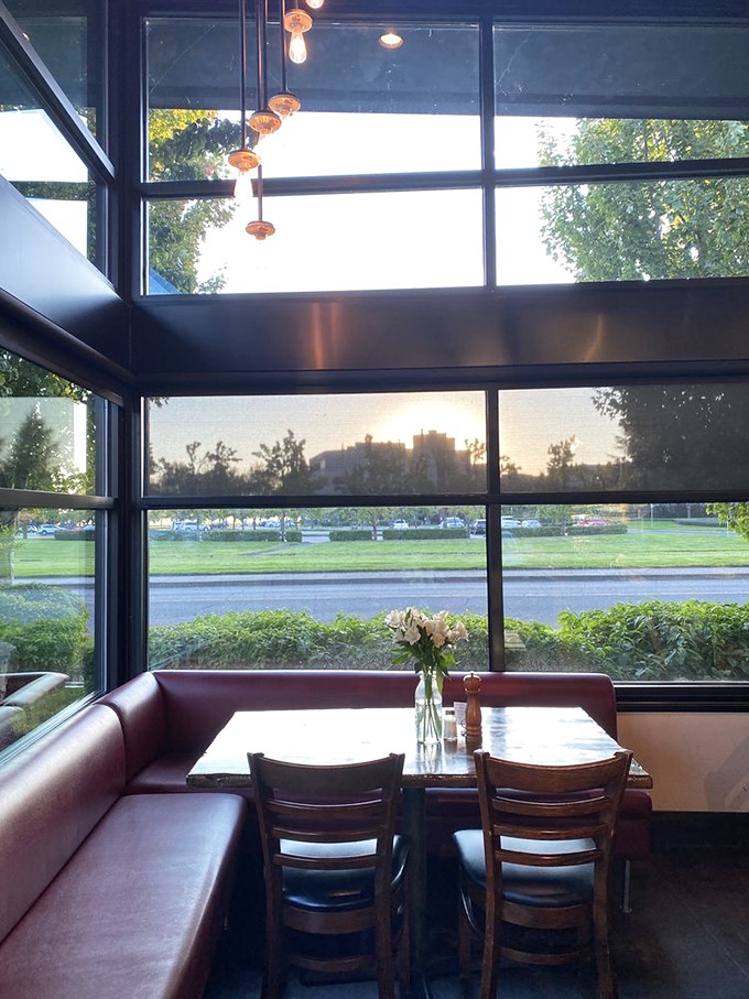 Corner booth nirvana: burgundy leather, warm wood, and windows that frame McMinnville like a living postcard. Some tables just feel luckier than others.