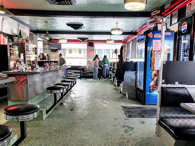 The diner's soul revealed&mdash;counter seating, booth tables, and the unmistakable energy of a place where conversations and coffee flow with equal abundance.