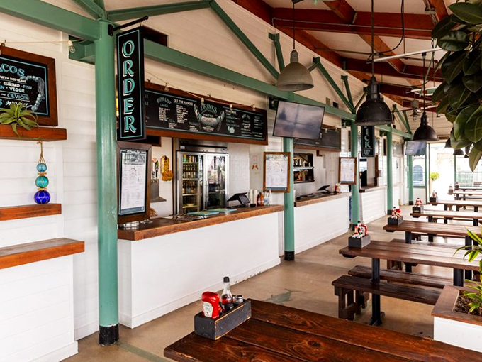 The ordering counter: where dreams are placed and seafood wishes are granted under the watchful gaze of industrial pendant lights.