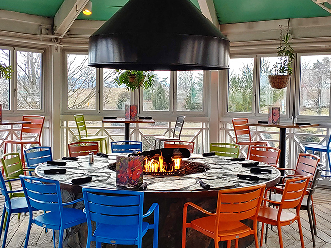 A fire table surrounded by rainbow-colored chairs creates the perfect gathering spot for making winter in Pennsylvania feel like summer somewhere else.