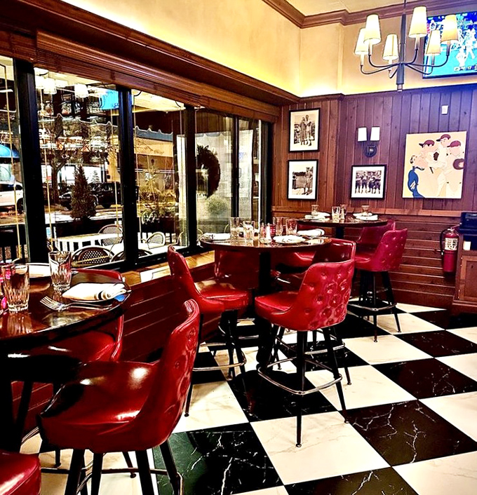 Black and white checkered floors meet red leather chairs&mdash;it's like a chess game where everyone wins with good food.
